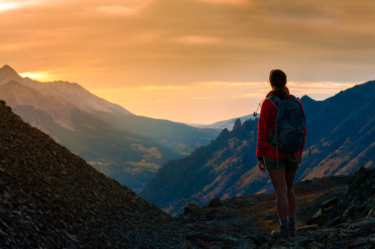 Backpacker Girl Looking at Sunset Colorado Mountains - Go Hike It